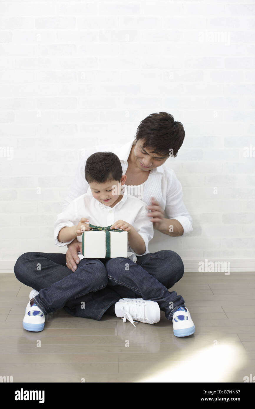 Father and son opening gift Stock Photo - Alamy