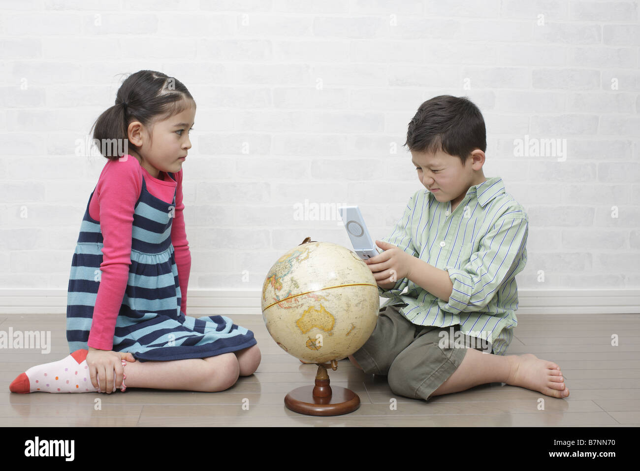 Children playing with a mobile phone Stock Photo - Alamy