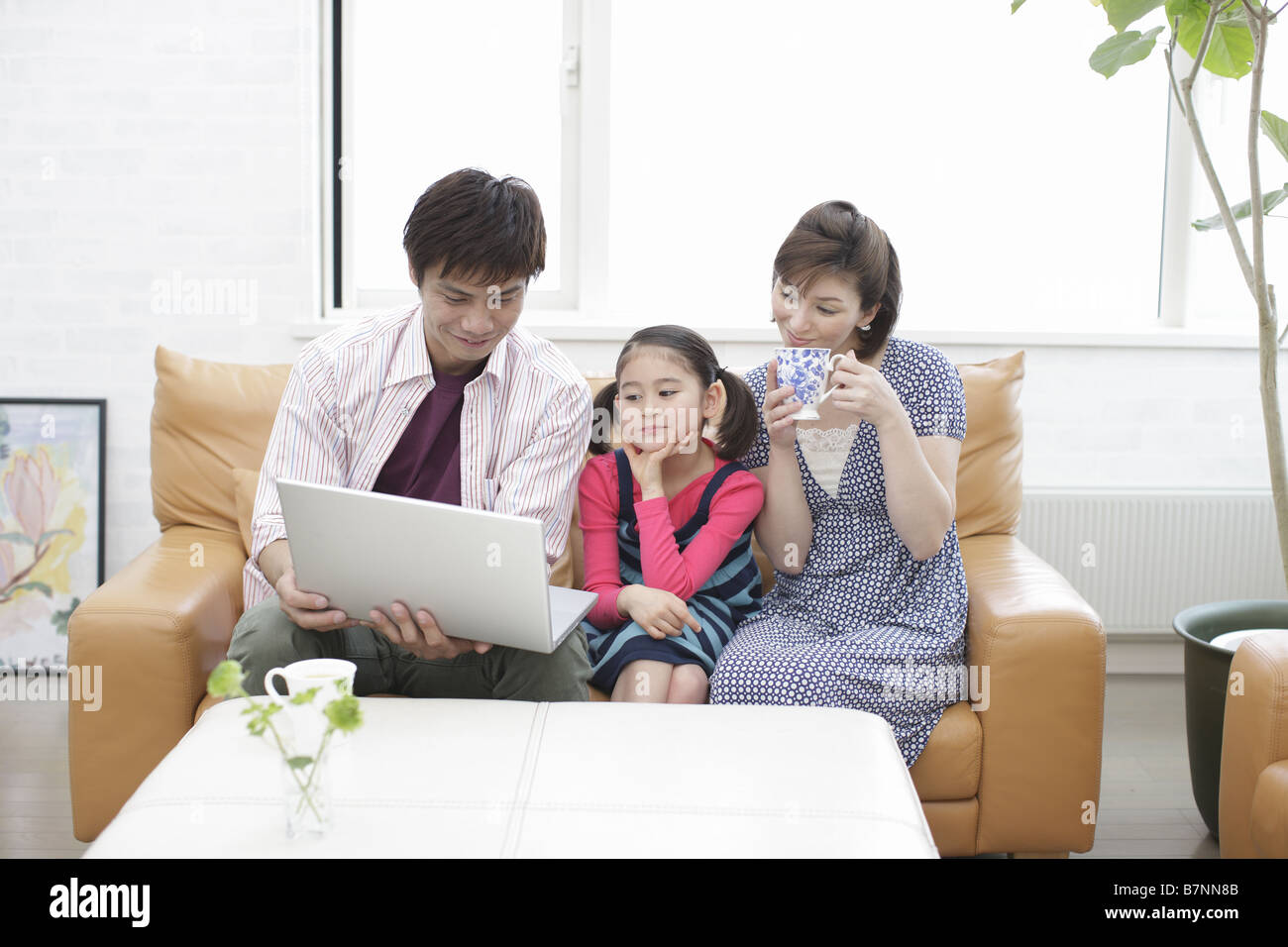 Family using computer Stock Photo - Alamy