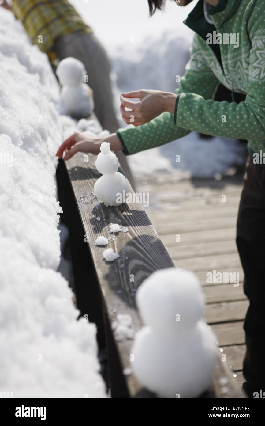 Two people with snowmen hi-res stock photography and images - Alamy