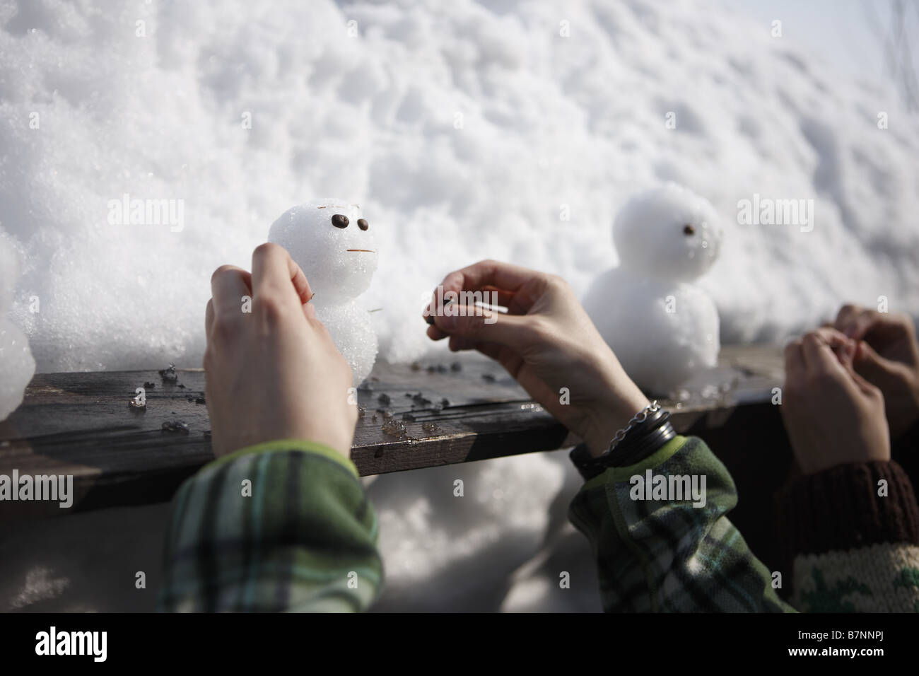 Two people with snowmen hi-res stock photography and images - Alamy