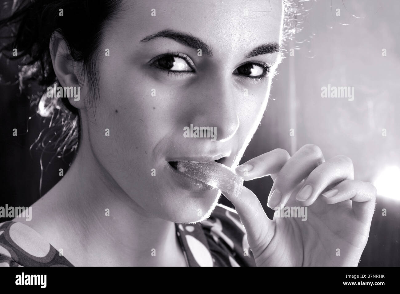 Woman eating a lemon slice Stock Photo - Alamy