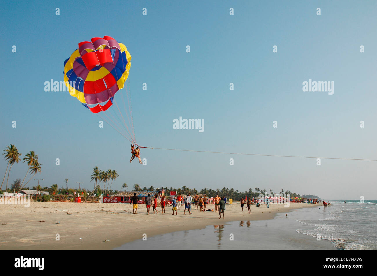 Parascending on a beach in Goa India Stock Photo - Alamy