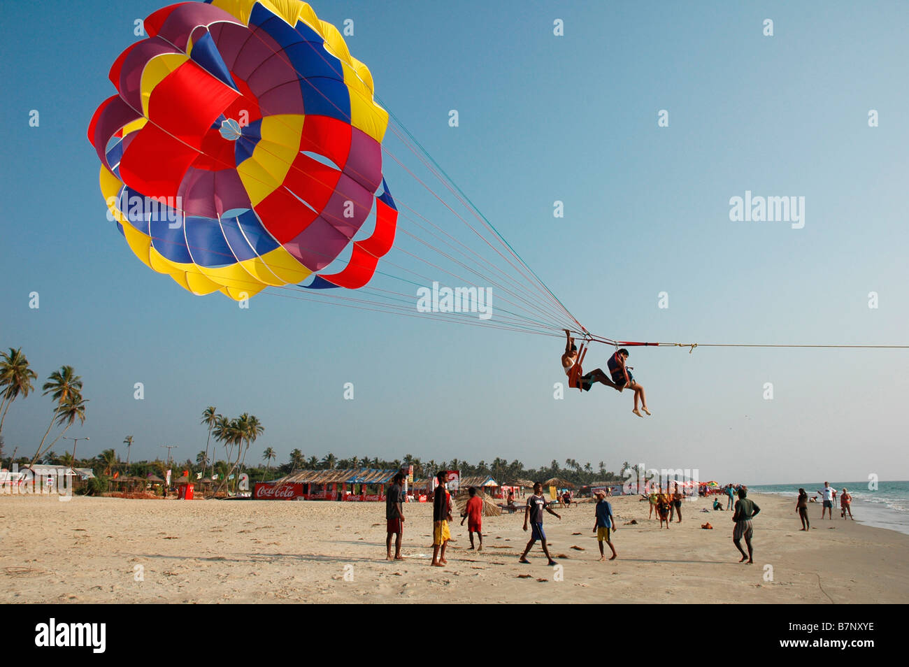 Parascending on a beach in Goa India Stock Photo - Alamy