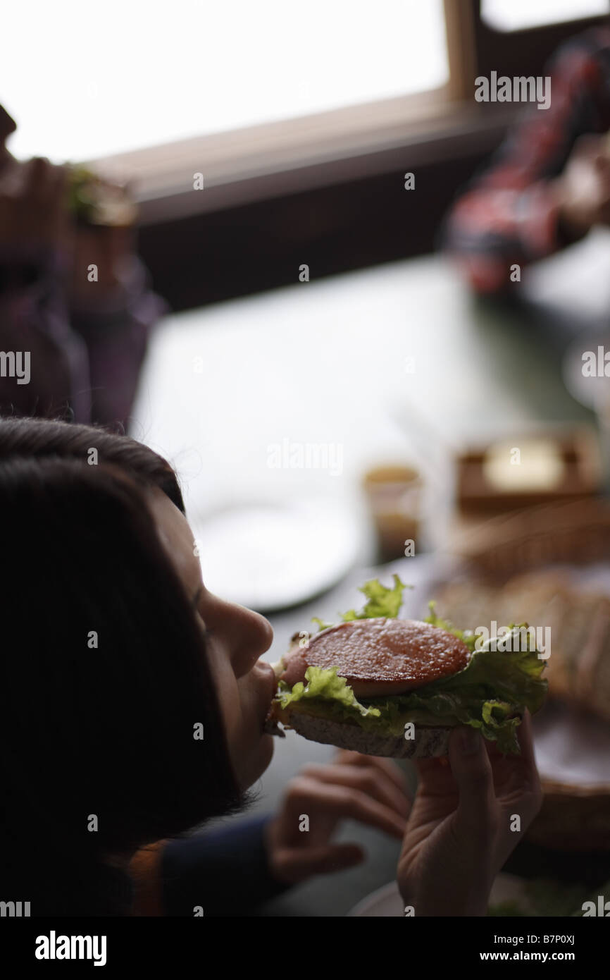 Young woman eating sausage sandwich hi-res stock photography and images ...