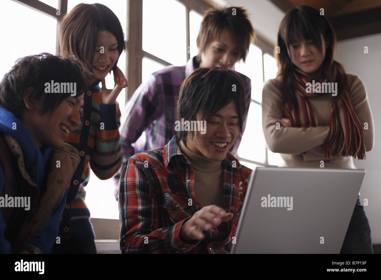 Young people having fun with laptop Stock Photo - Alamy