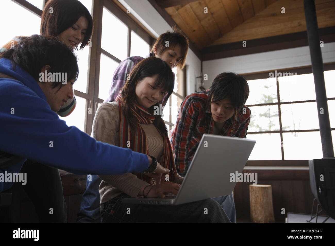 Young people having fun with laptop Stock Photo - Alamy