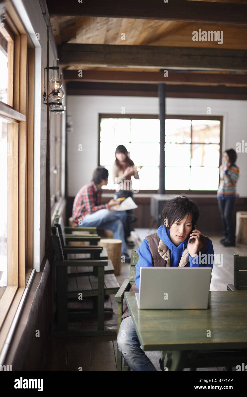 Young people using laptop Stock Photo - Alamy