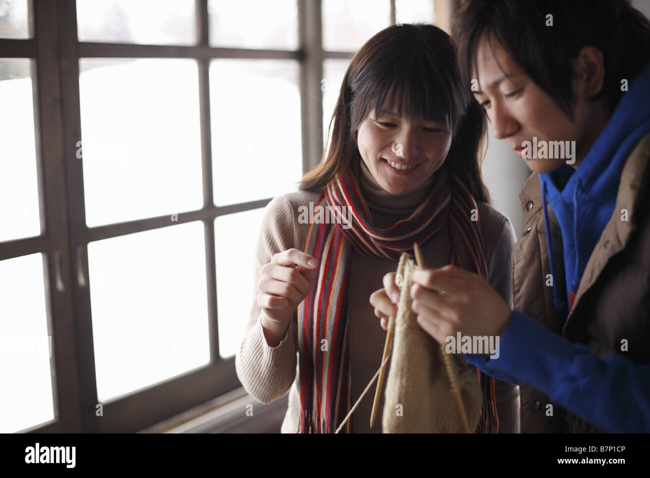 Couple knitting together Stock Photo - Alamy