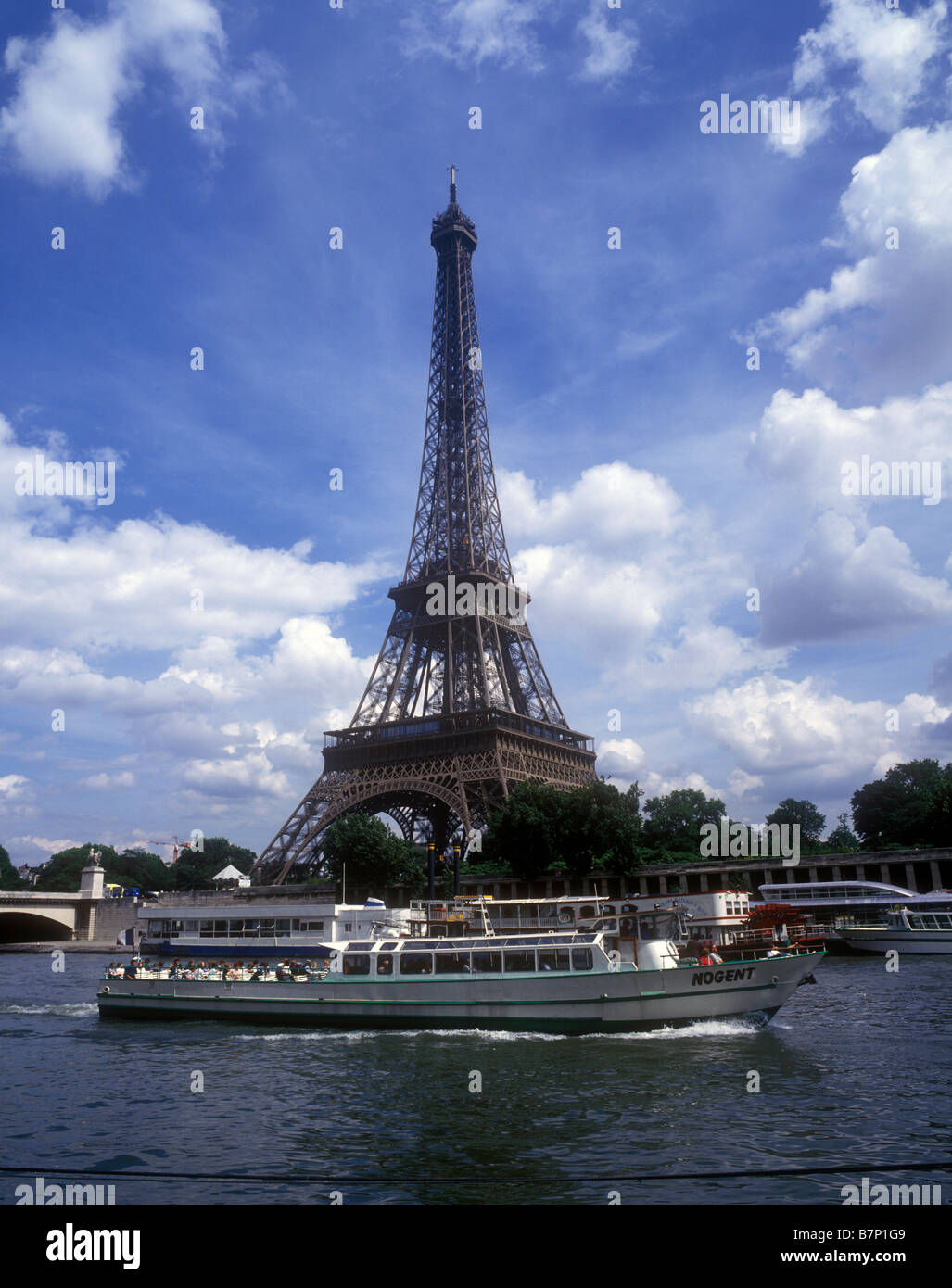 A River Seine tour boat passing the Eiffel Tower Stock Photo - Alamy