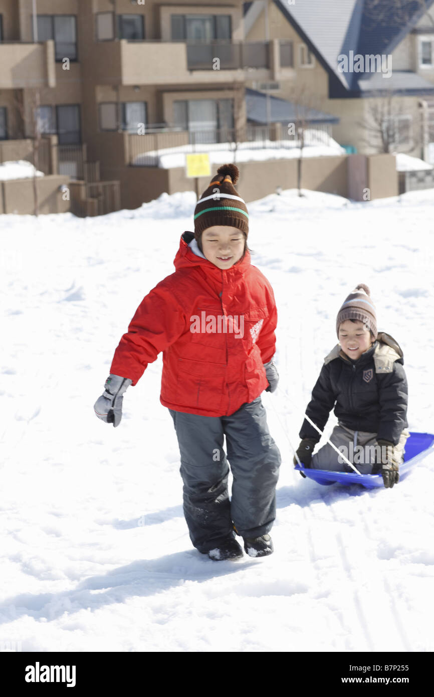 Children at play sledding Stock Photo - Alamy
