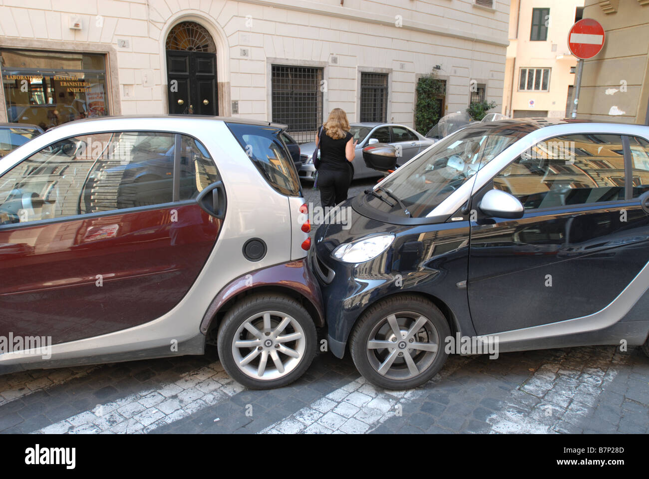 Two Smart cars parked close together on a crowded street in Rome Stock ...