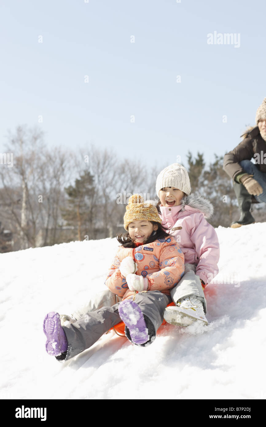Children at play sledding Stock Photo - Alamy