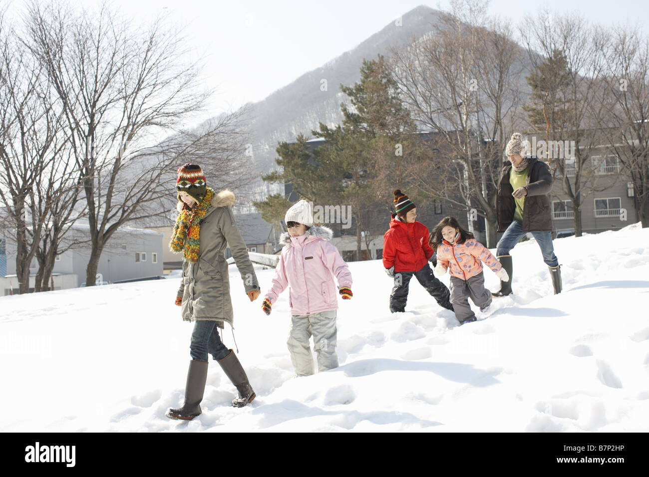 Family walking in the snowfield Stock Photo - Alamy