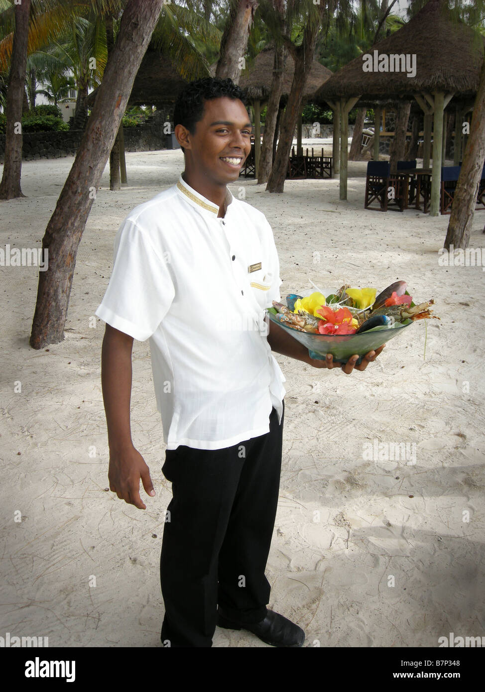 Waiter on the Beach at Belle Mare Mauritius Stock Photo - Alamy
