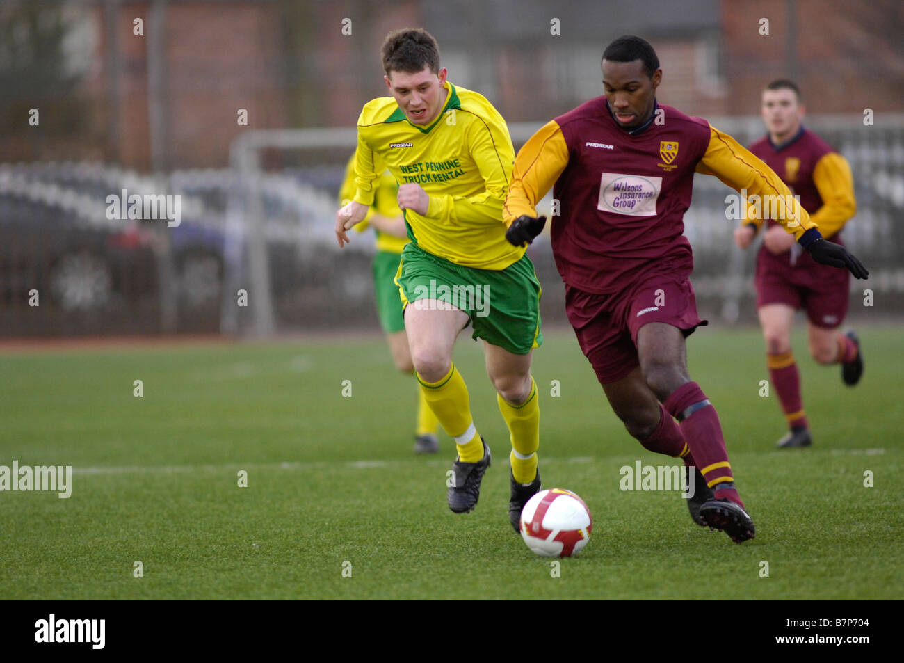 two footballers battling for the ball Stock Photo - Alamy