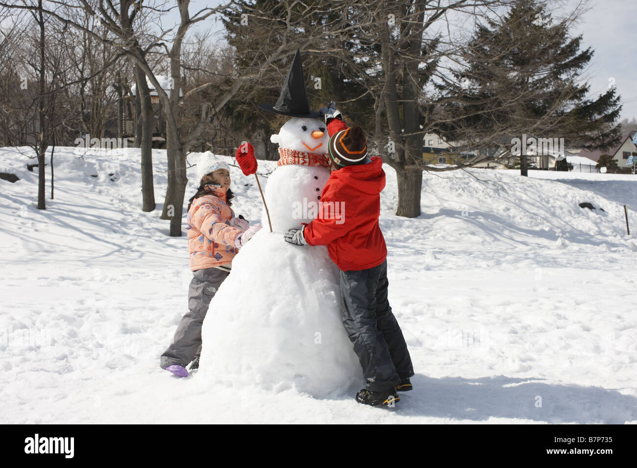 Two boys making a snowman hi-res stock photography and images - Alamy