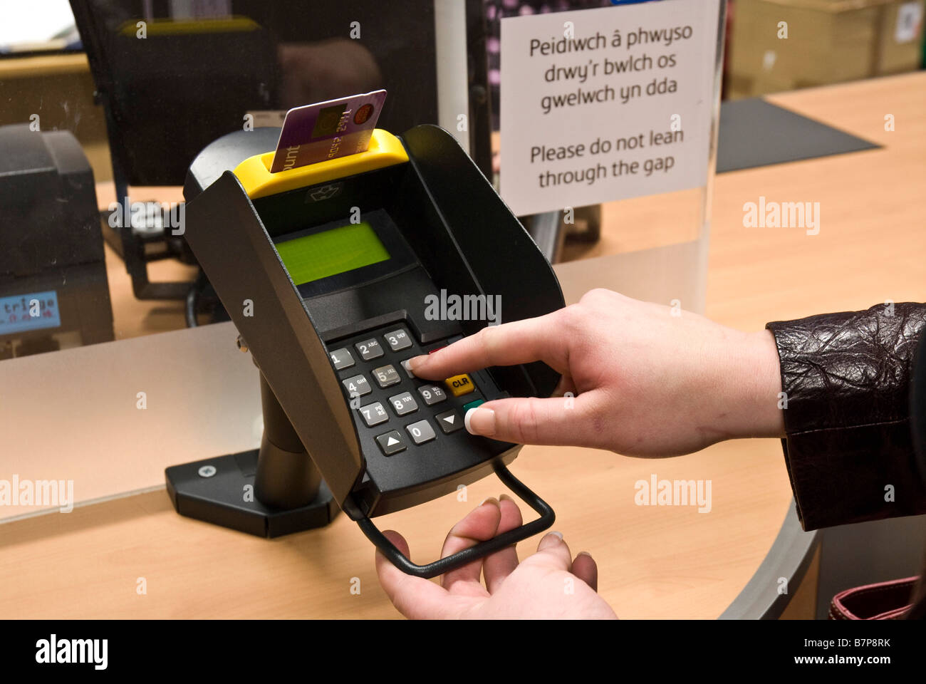 Entering PIN number at Post Office Counter Stock Photo - Alamy