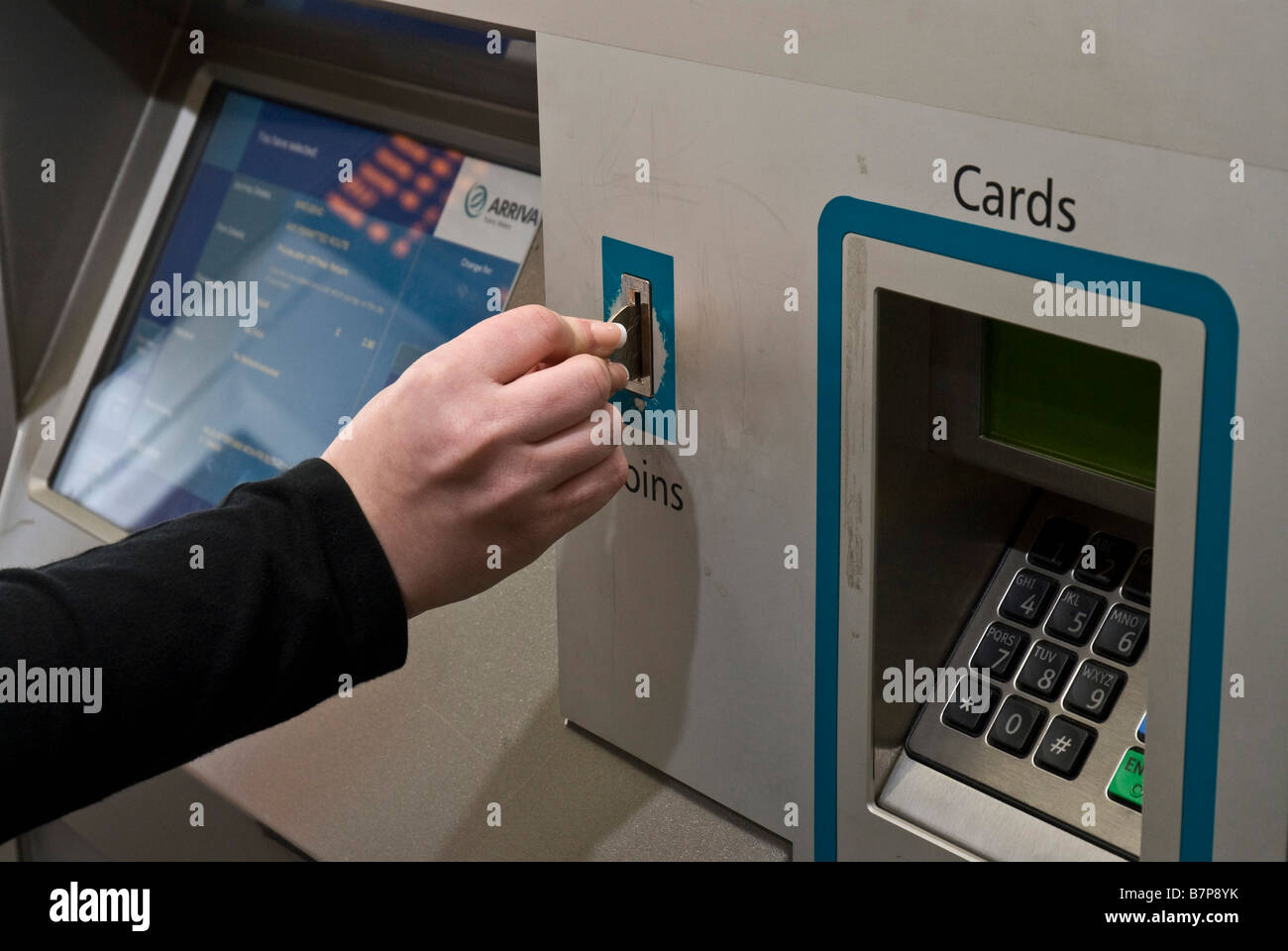 Inserting a Coin into a Rail Ticket Vending Machine Stock Photo - Alamy