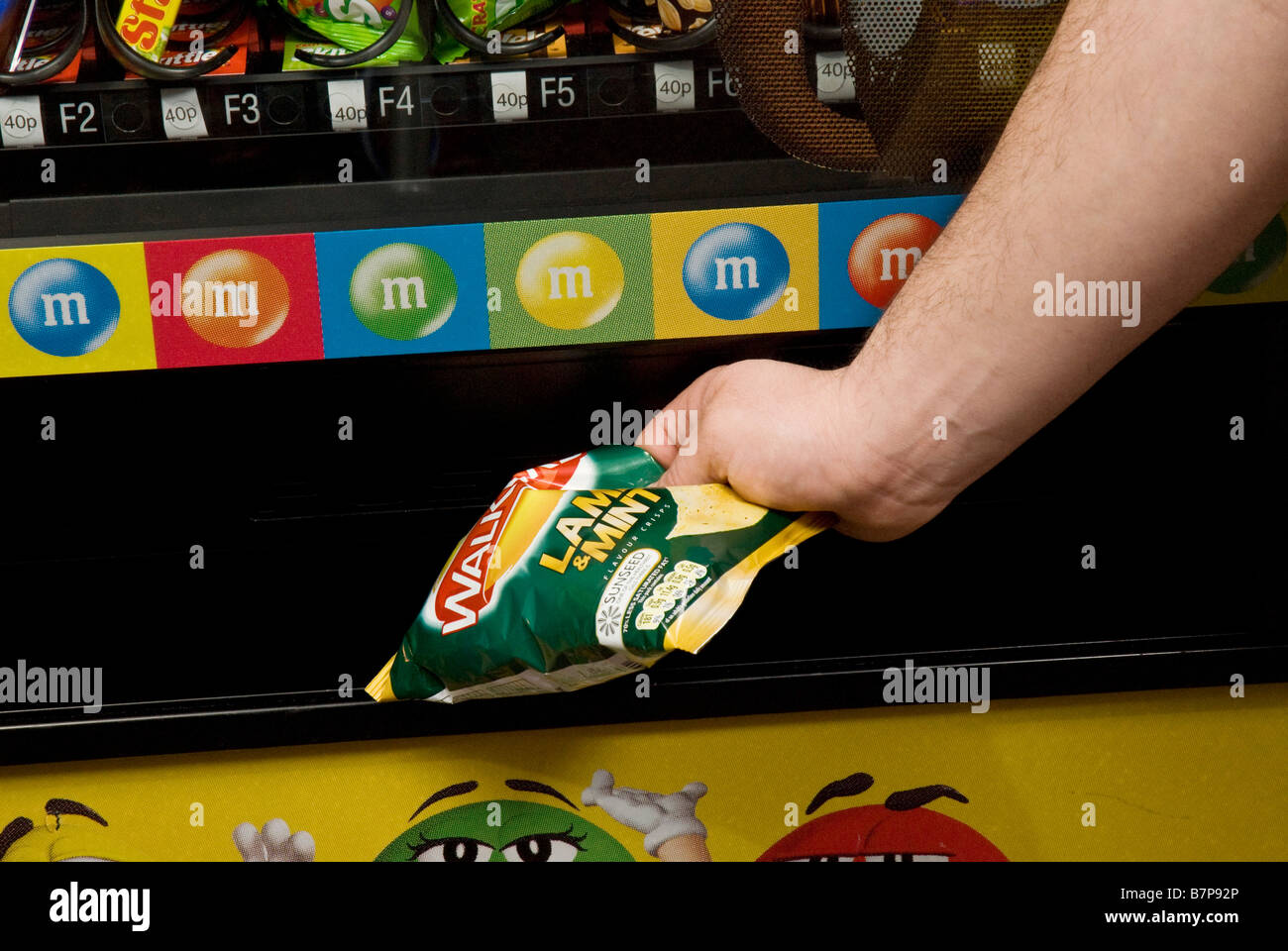 Taking Product from a Vending Machine Stock Photo - Alamy