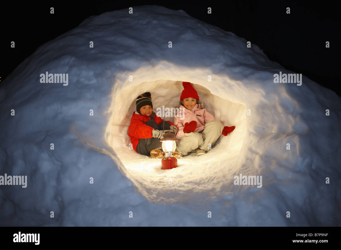 Children playing in a snow cave Stock Photo - Alamy