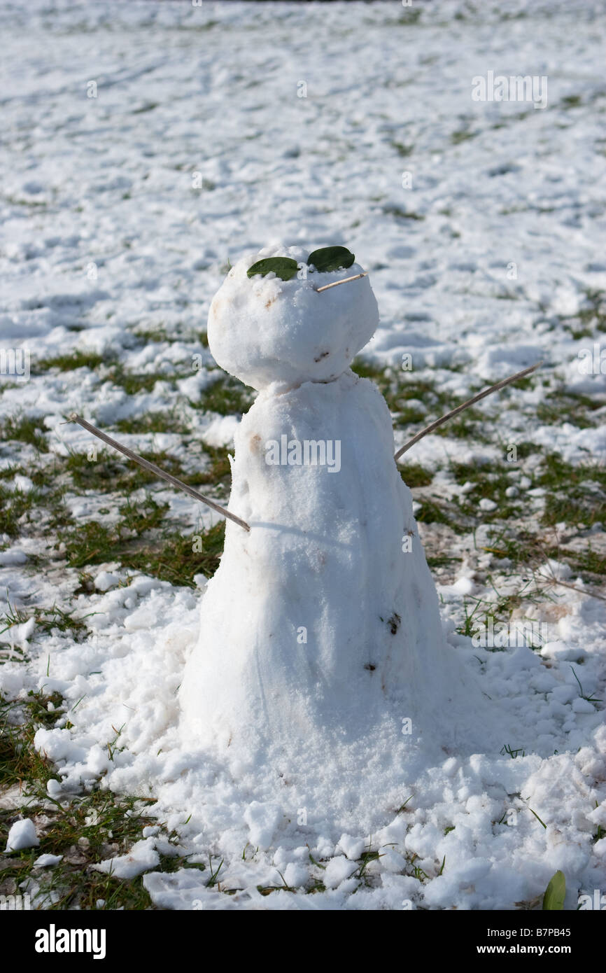 Snowman with sticks for arms hi-res stock photography and images - Alamy