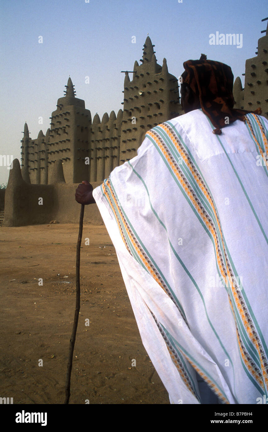 Man standing outside the great mud mosque at Djenne Mali West Africa ...