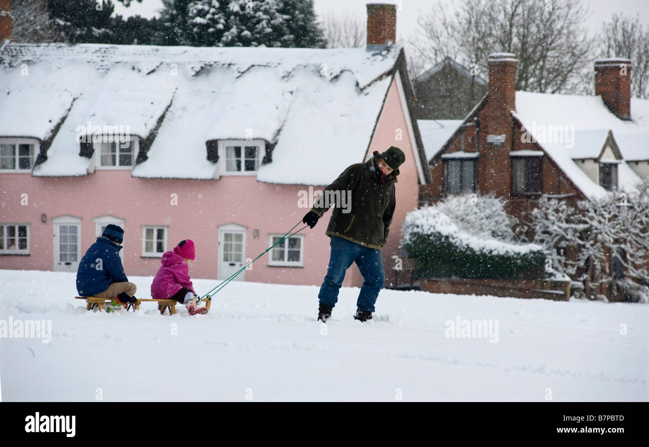 Cavendish Suffolk Britain A father pulls his children along on a ...