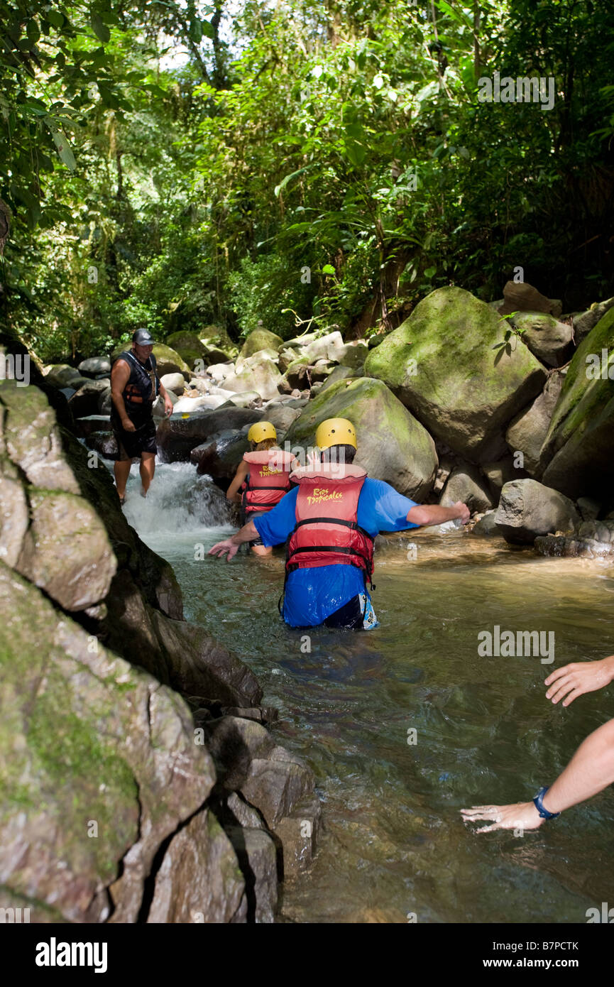 Central America, Costa Rica. Rafters explore a creek that leads to a ...