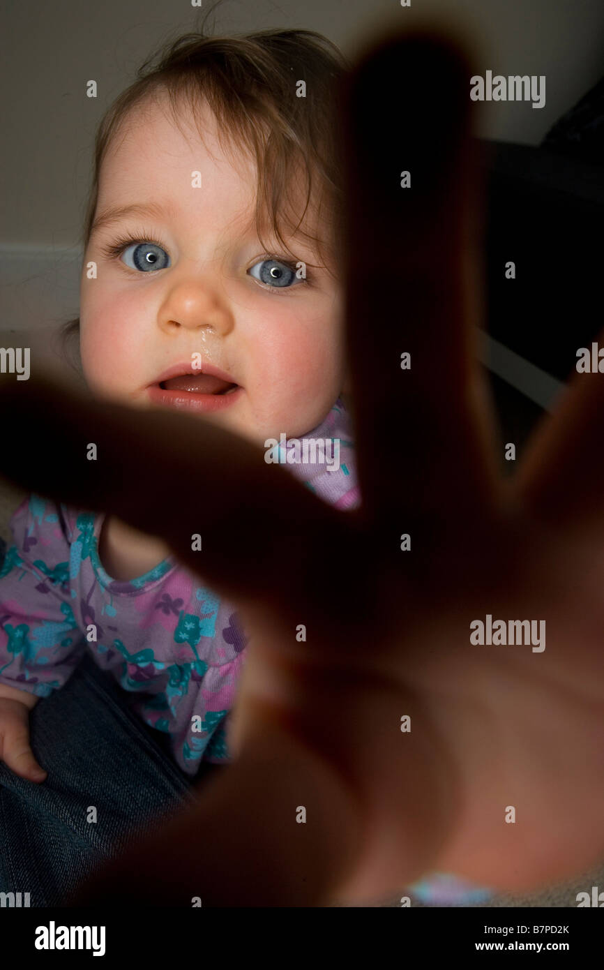 A baby girl reaches out to grab something Stock Photo - Alamy