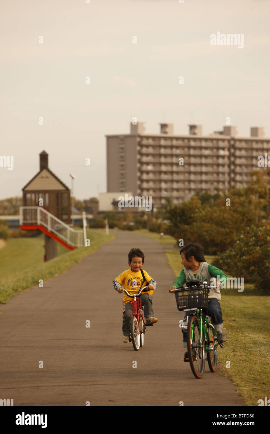 Brothers riding bicycles Stock Photo - Alamy