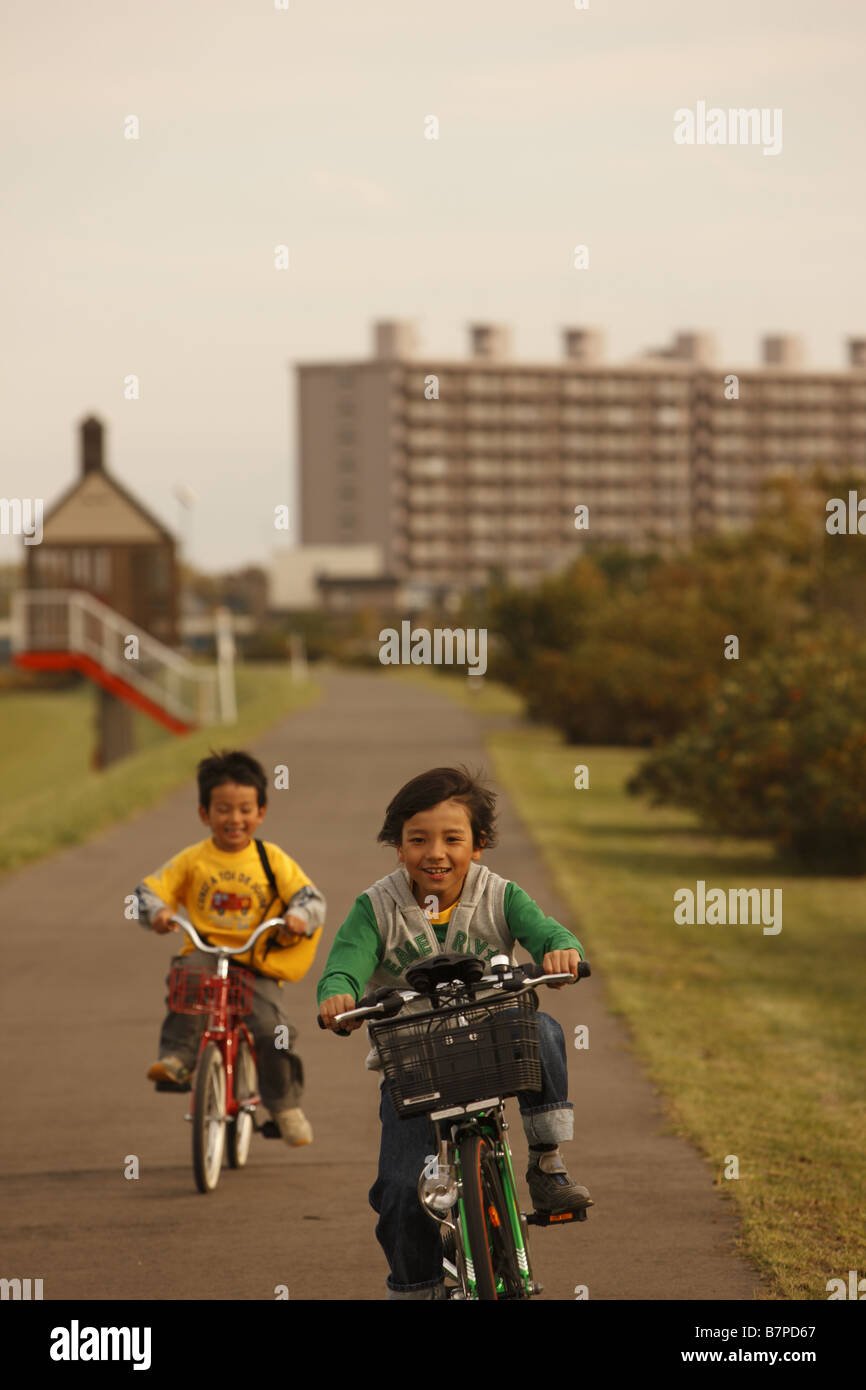 Brothers riding bicycles Stock Photo - Alamy