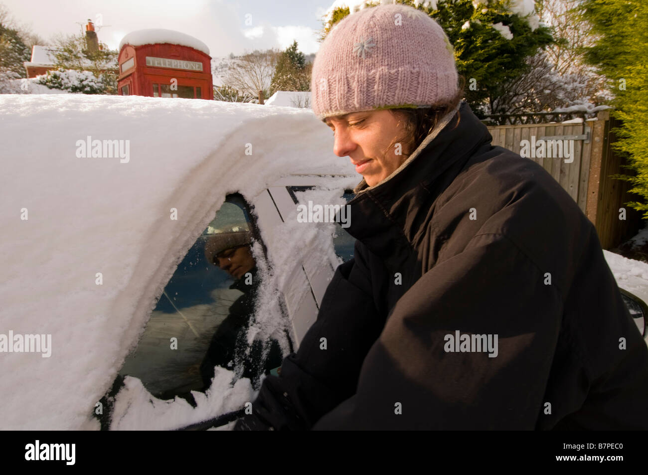 woman cleaning her snow off her car Stock Photo - Alamy
