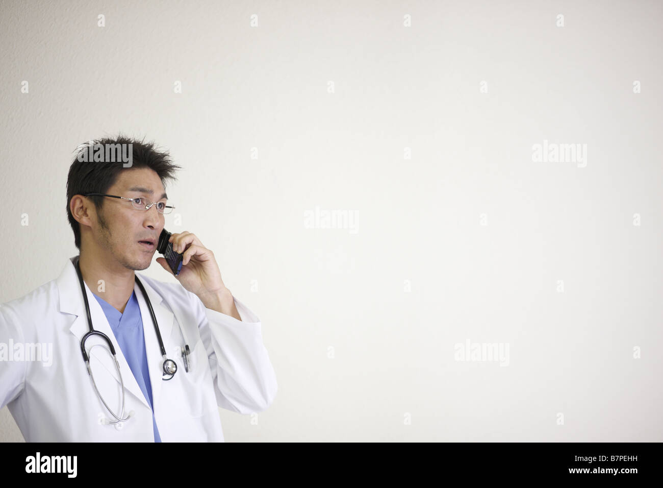 Doctor calling cell phone Stock Photo - Alamy