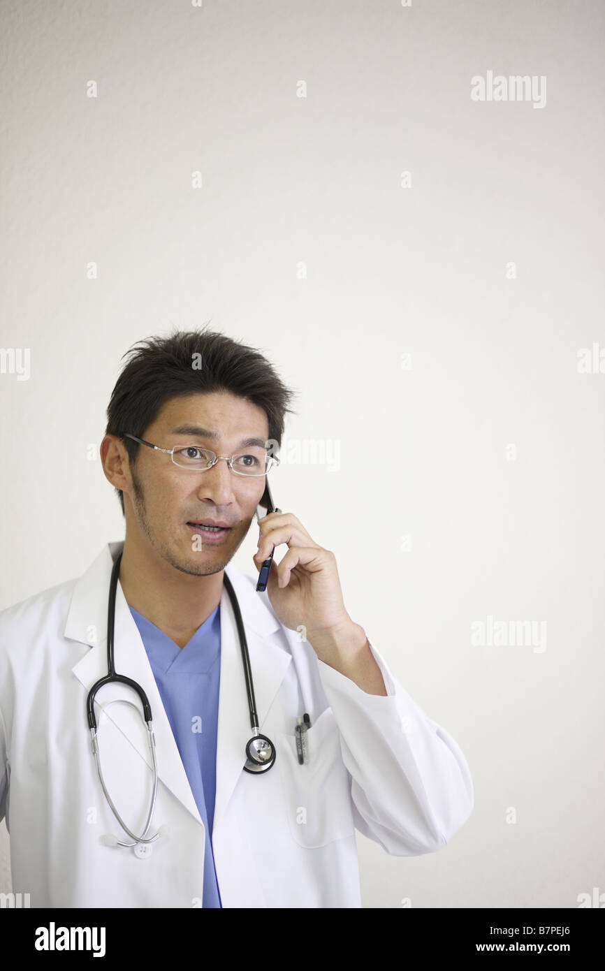 Doctor calling cell phone Stock Photo - Alamy