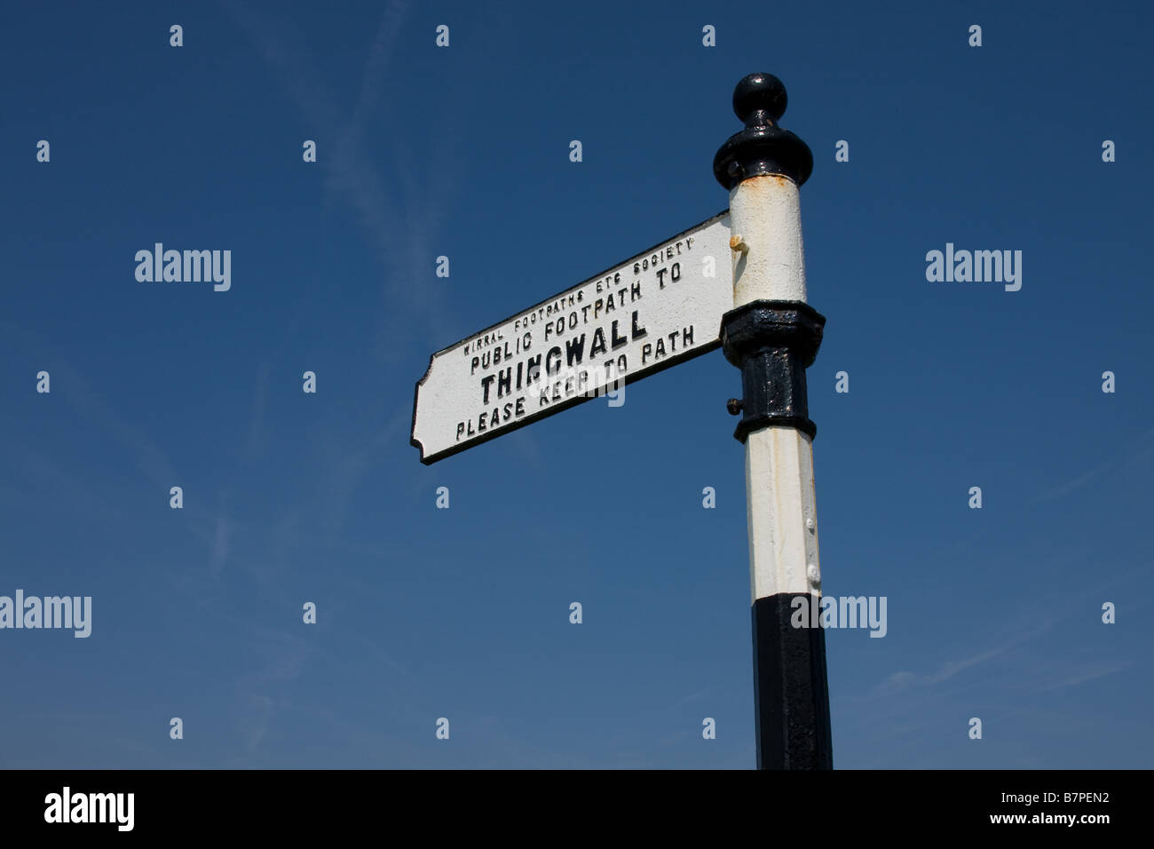 A public footpath sign in England, UK, against a blue sky background ...