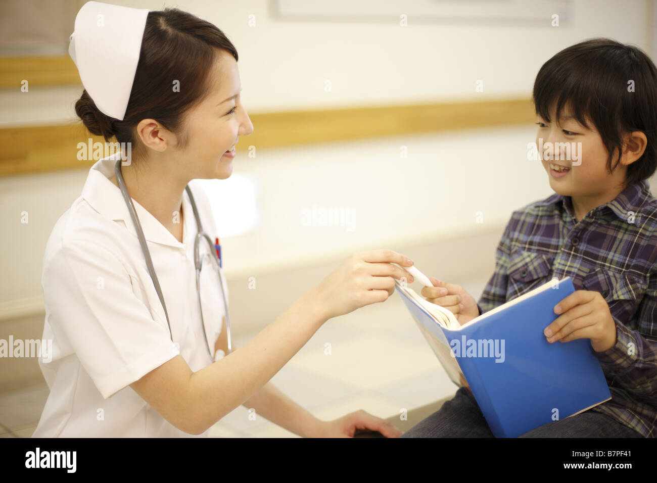 Smiling nurse and a boy Stock Photo - Alamy