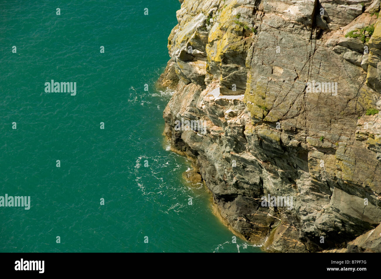 Aerial view of sheer cliff face and sea below. South Stack. Holyhead ...
