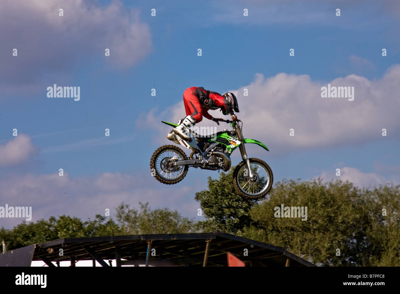A daredevil stunt motorbike rider jumping through the air Stock Photo ...