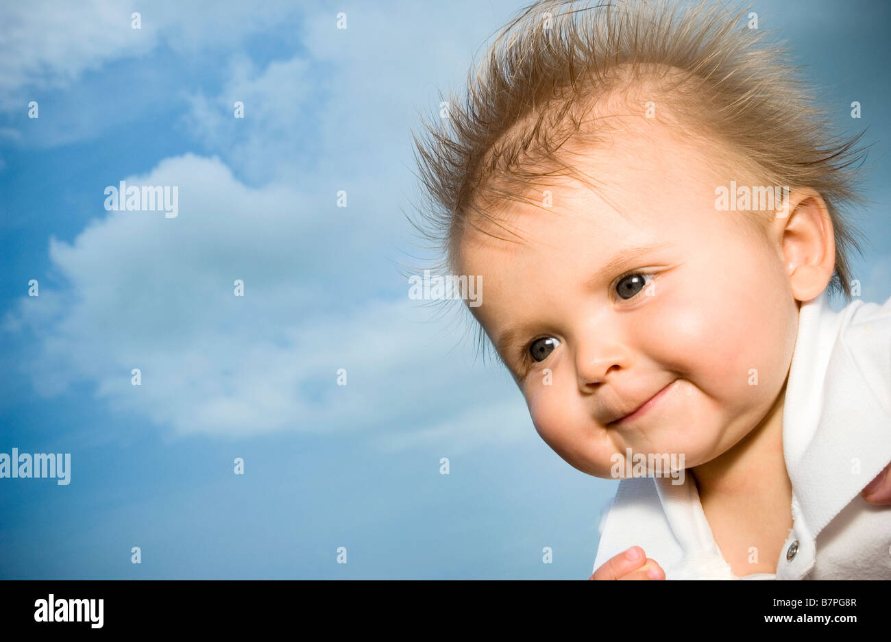 baby smiling with blue sky background Stock Photo - Alamy