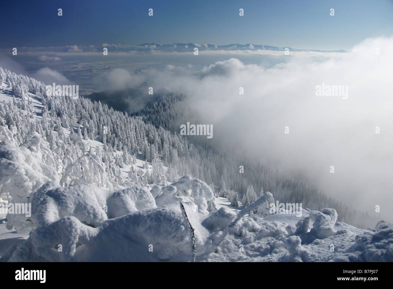 Liptov area in Slovakia winter from Mt. Choc mountain with fog clouds ...