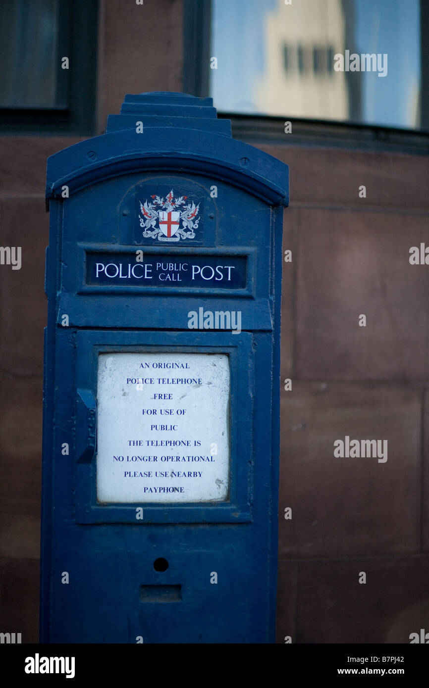 Blue Police Box in London to left with tower in reflection window to ...