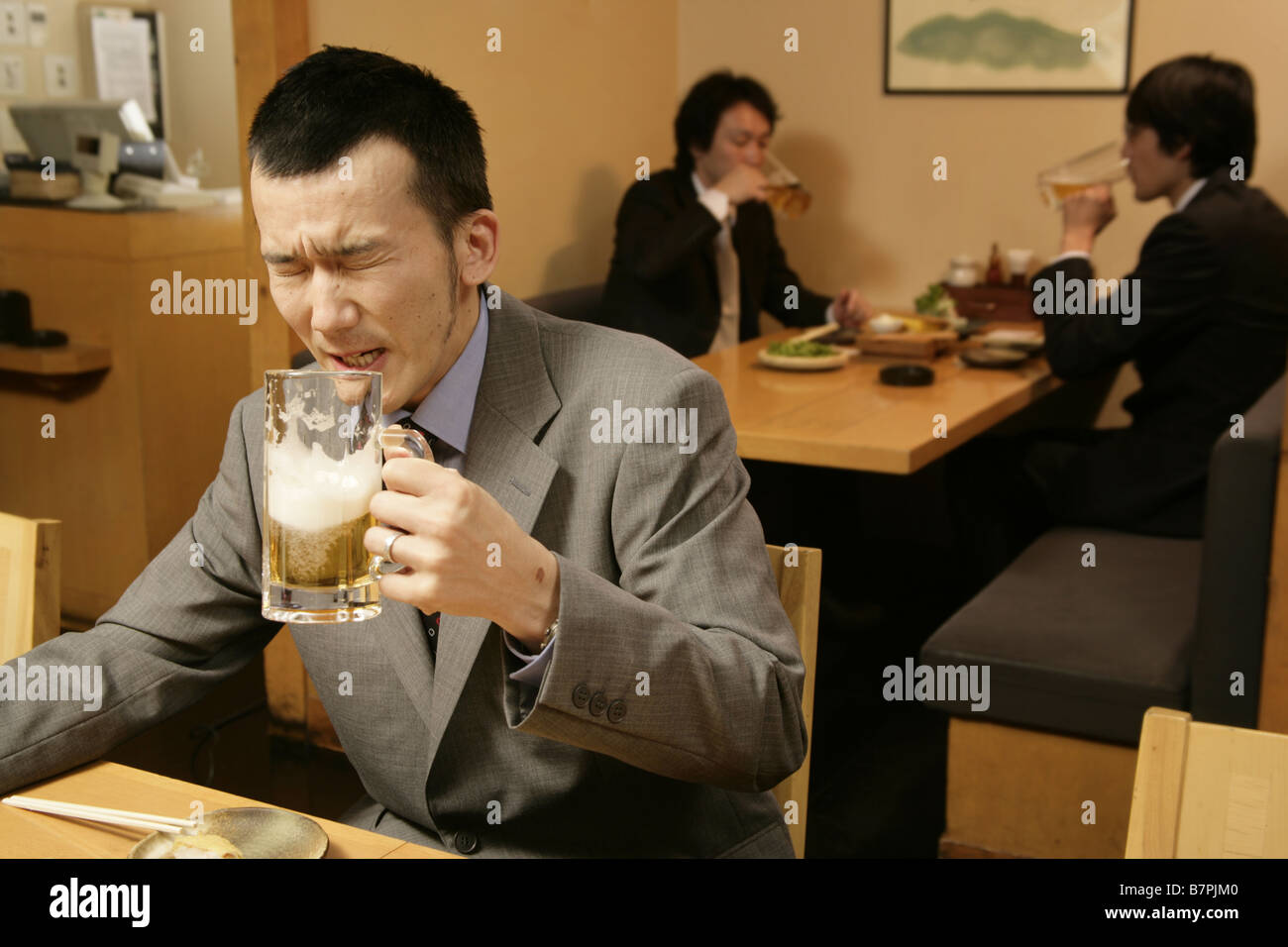Man drinking beer in the Japanese-style pub Stock Photo - Alamy