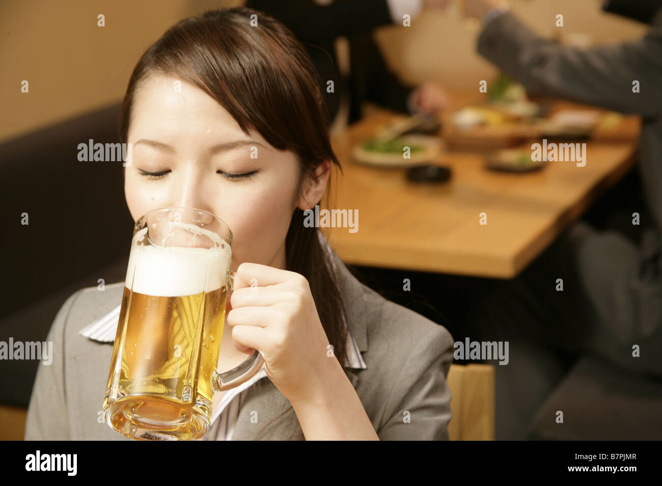 Woman drinking beer in the Japanese-style pub Stock Photo - Alamy