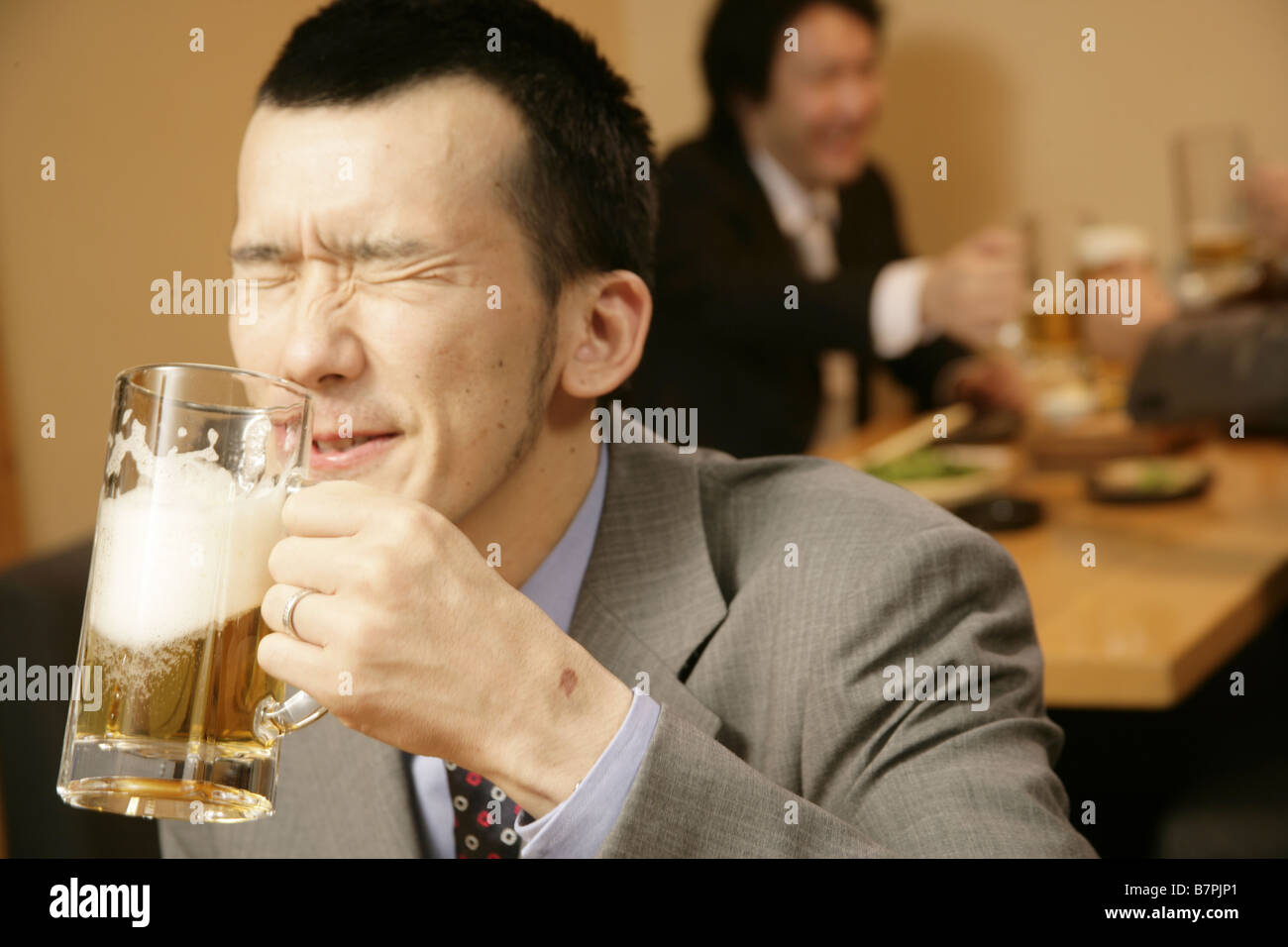 Man drinking beer in the Japanese-style pub Stock Photo - Alamy