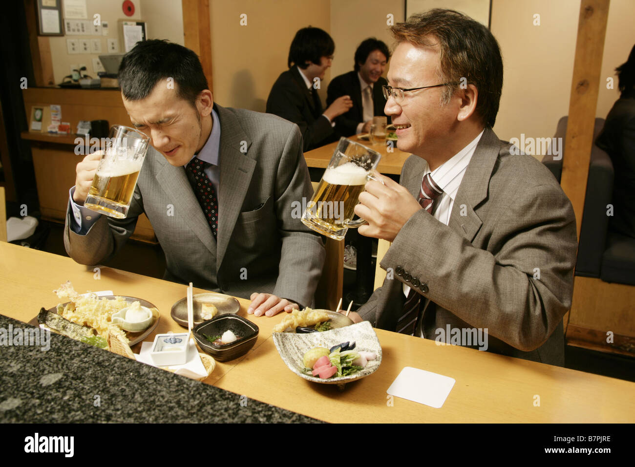 Man drinking beer in the Japanese-style pub Stock Photo - Alamy