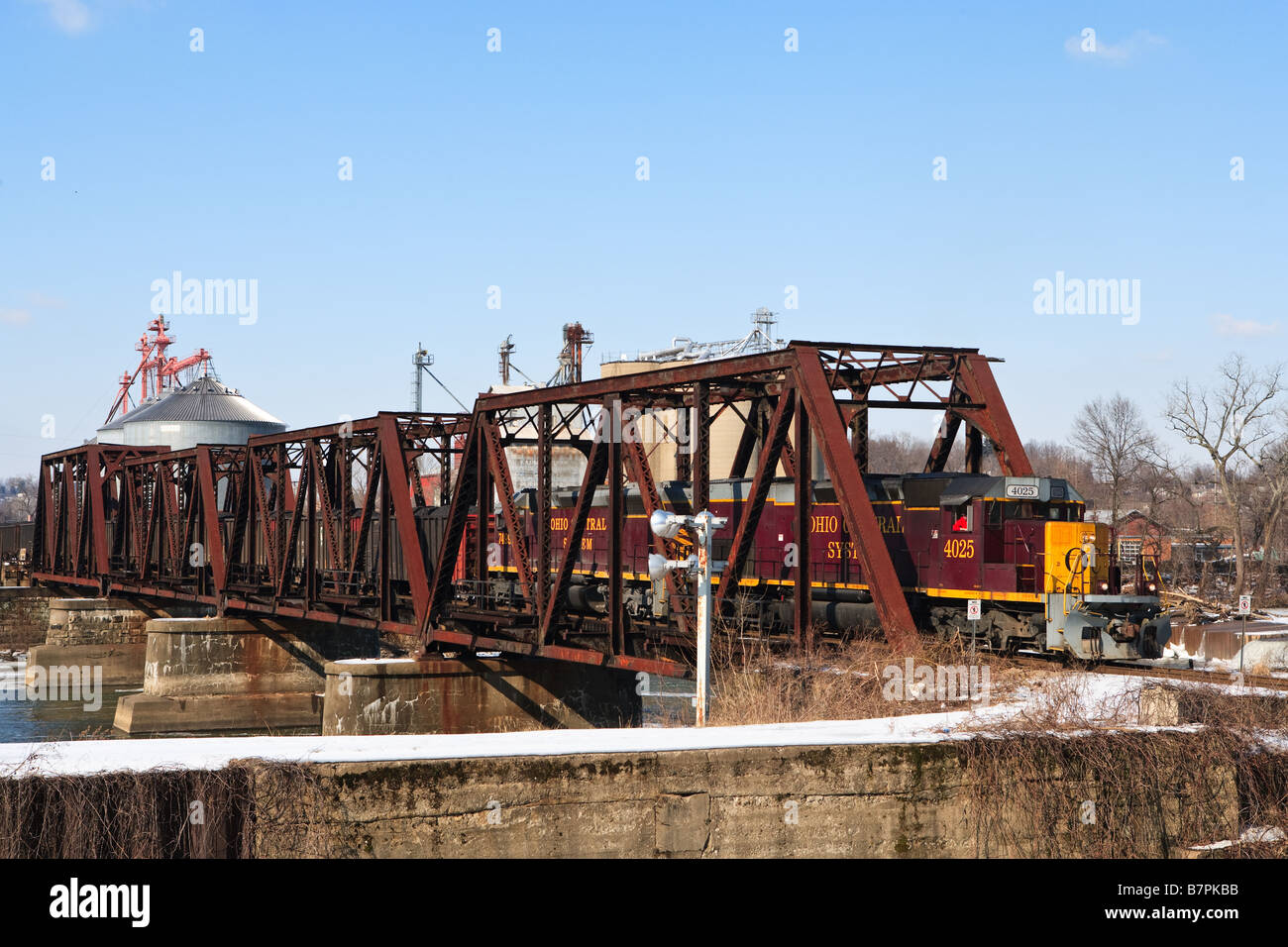 A freight train carrying coal is coming accross a railroad bridge Stock ...
