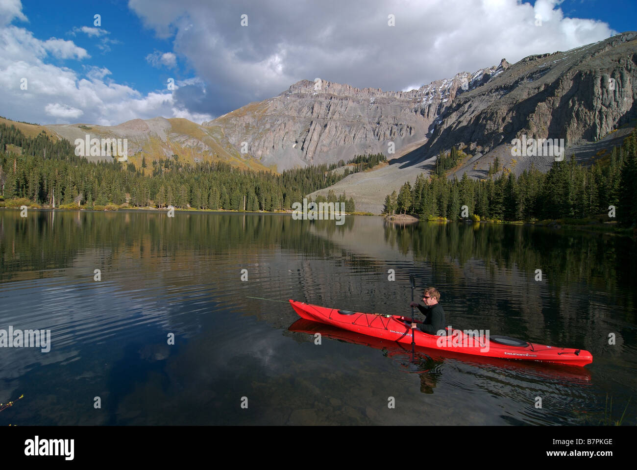 a man kayaking in the evening on a high alpine lake in colorado Stock ...