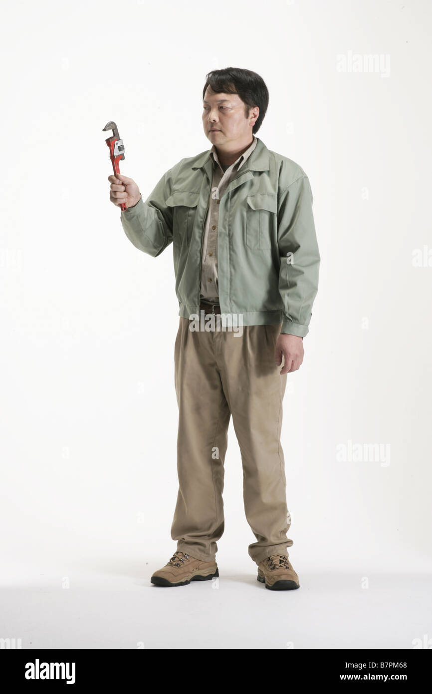 Man holding wrench hi-res stock photography and images - Alamy