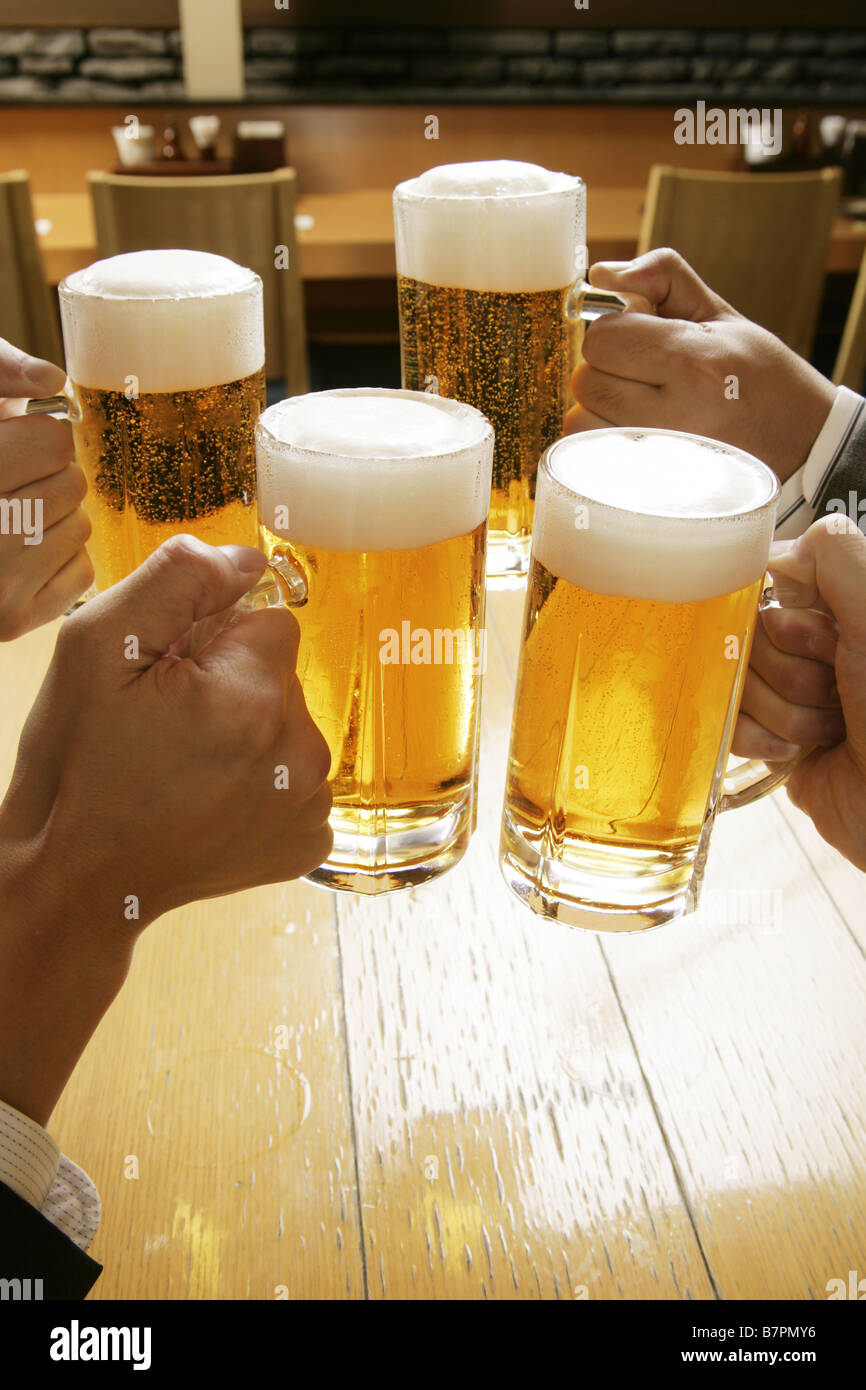 Making a toast with beer Stock Photo - Alamy